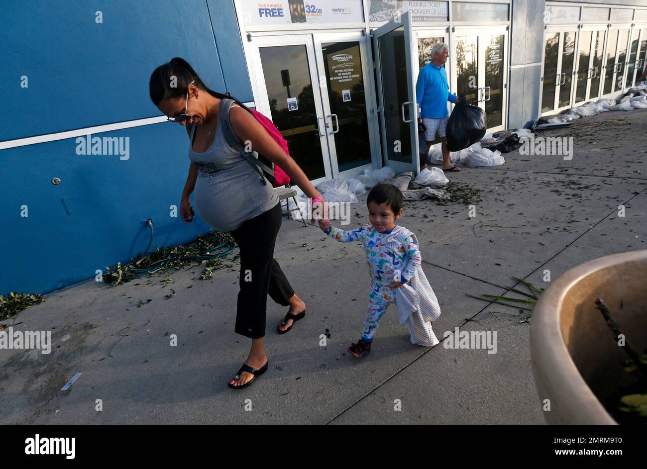 Stacy Pastoriza and her son Alfredo, 2, of Cape Coral, Fla., leave the ...