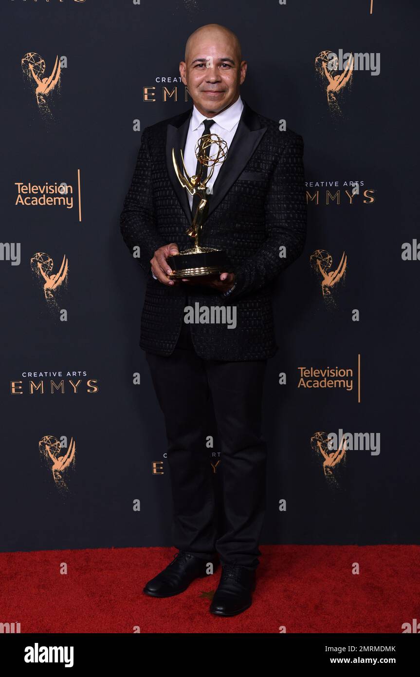 Eddie Perez poses in the press room with the award for outstanding ...