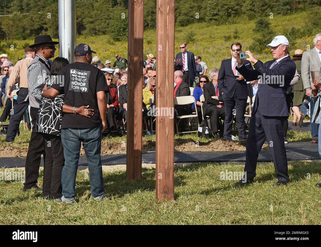 Secretary of the Interior Ryan Zinke takes a photo of family who lost a ...