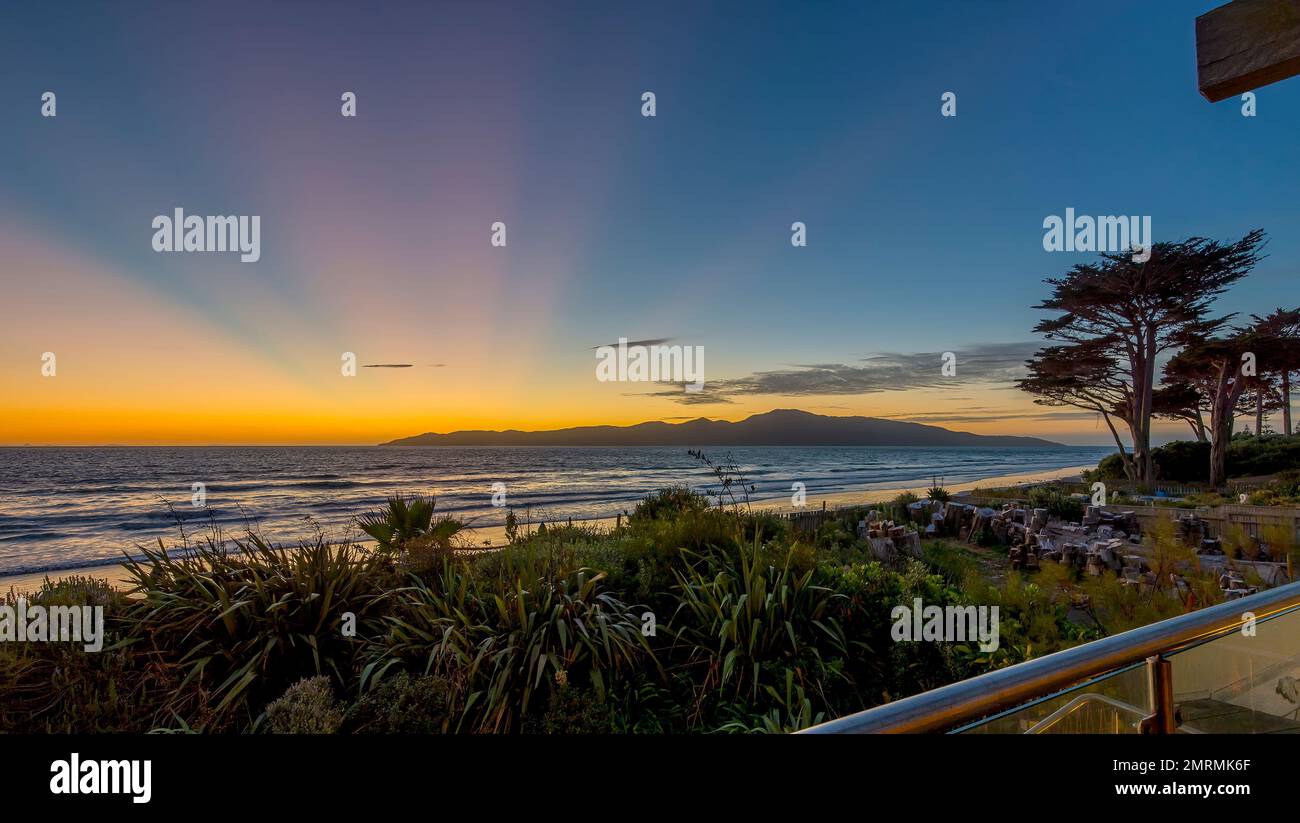 The scenic Raumati Beach at vivid sunset in New Zealand Stock Photo - Alamy