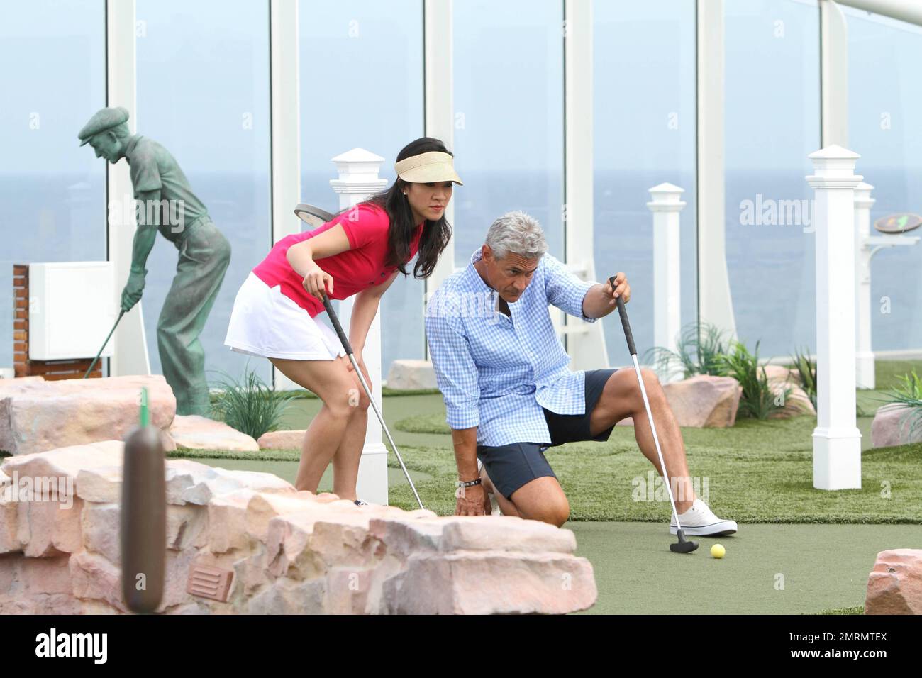 Michelle Kwan and Greg Louganis play a round of mini-golf while onboard ...