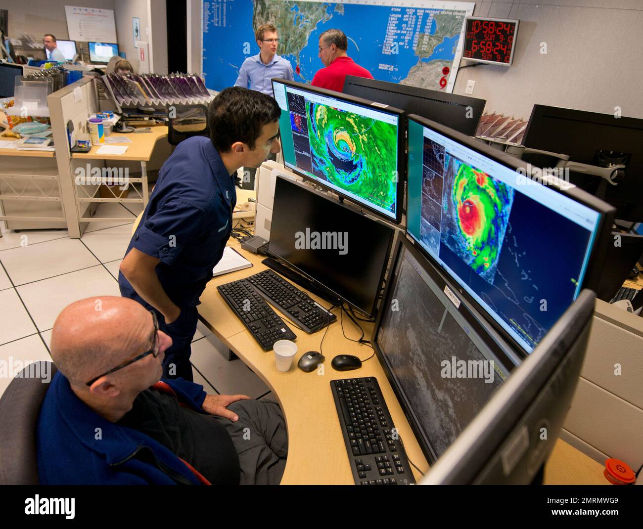 Senior Hurricane Specialist Lixion Avila, left, and Lt. Phil Manougian ...