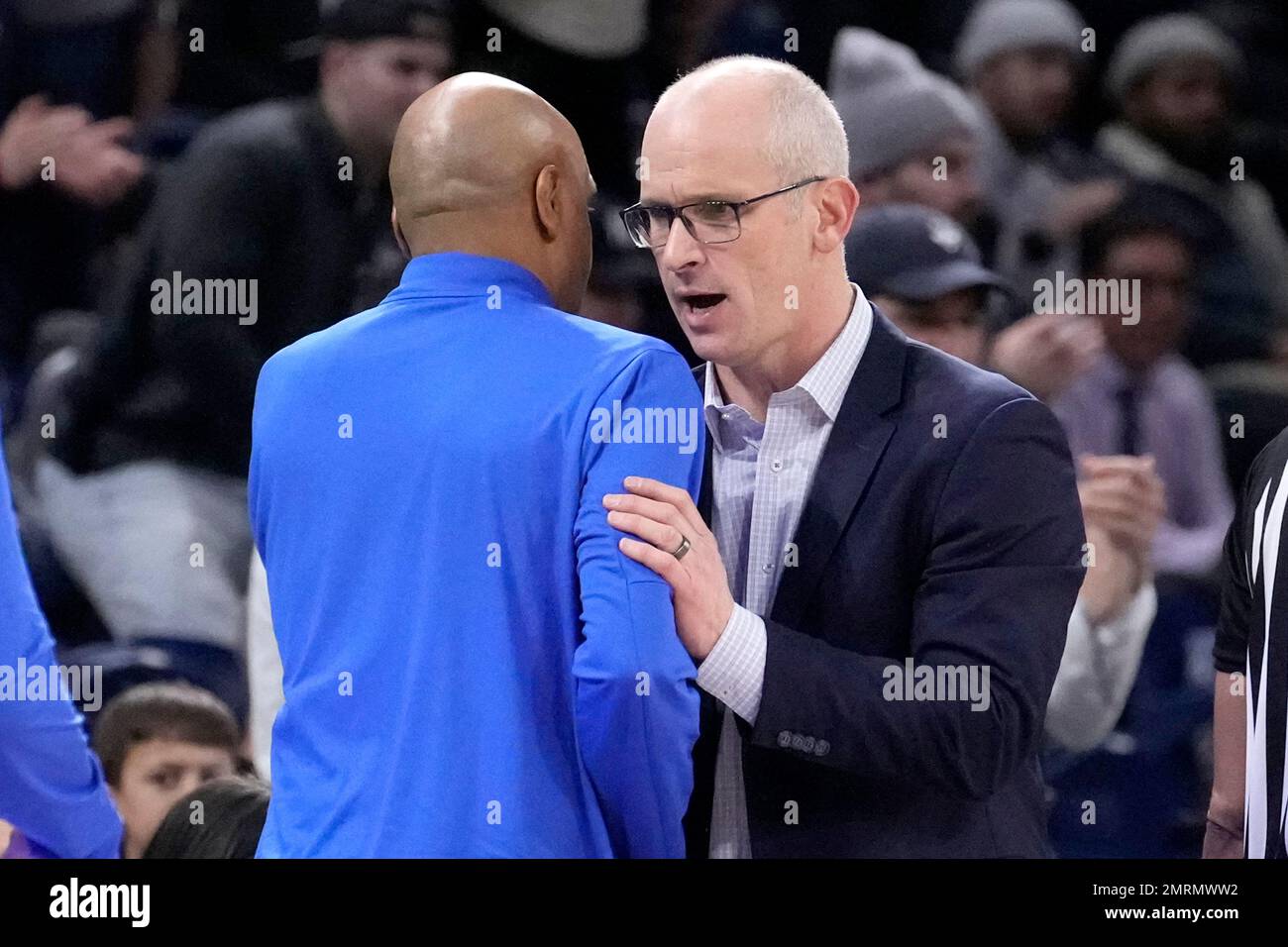 Connecticut head coach Dan Hurley, right, talks with DePaul head coach ...