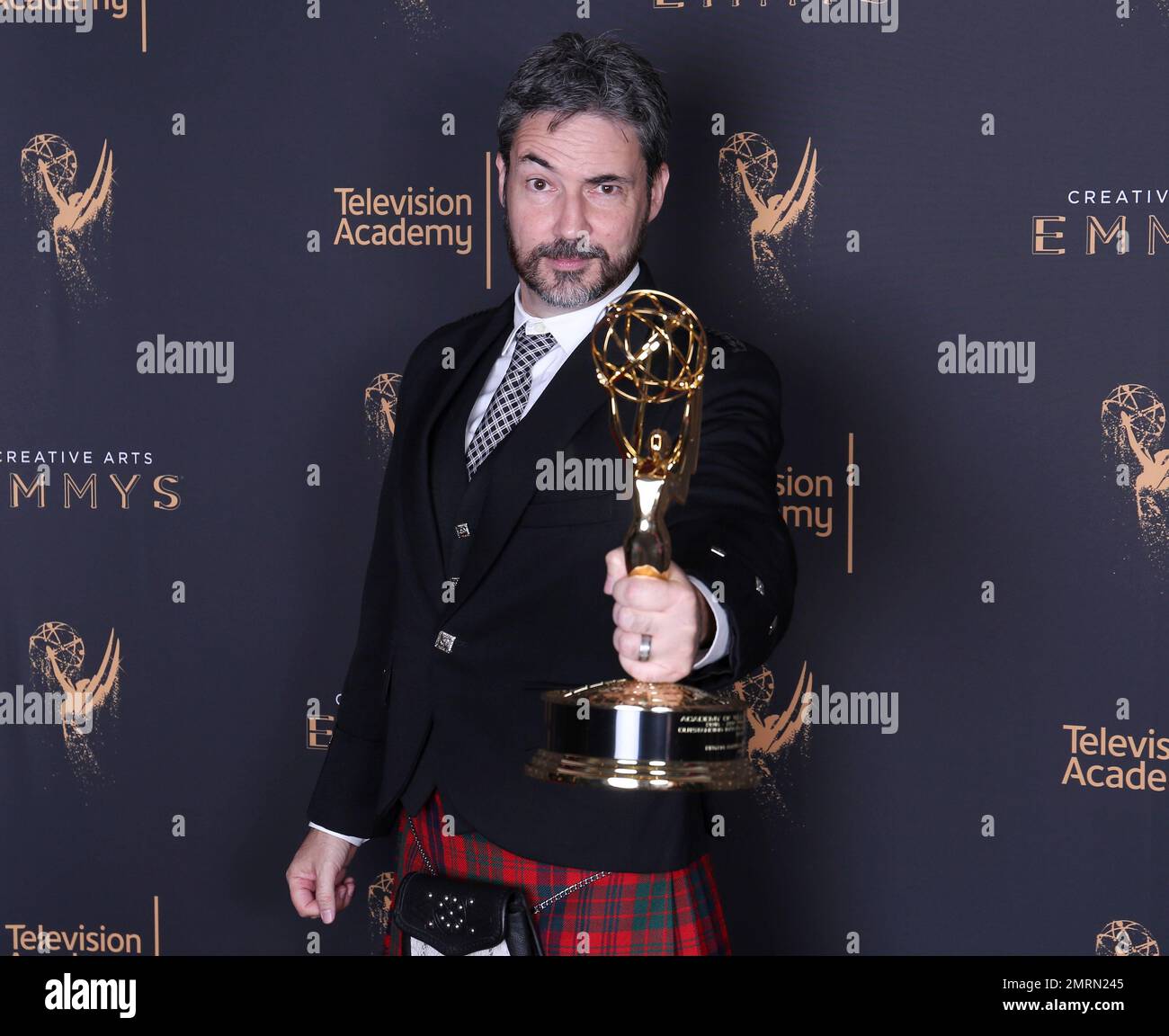 EXCLUSIVE - Bryan Andrews poses for a portrait with the award for ...