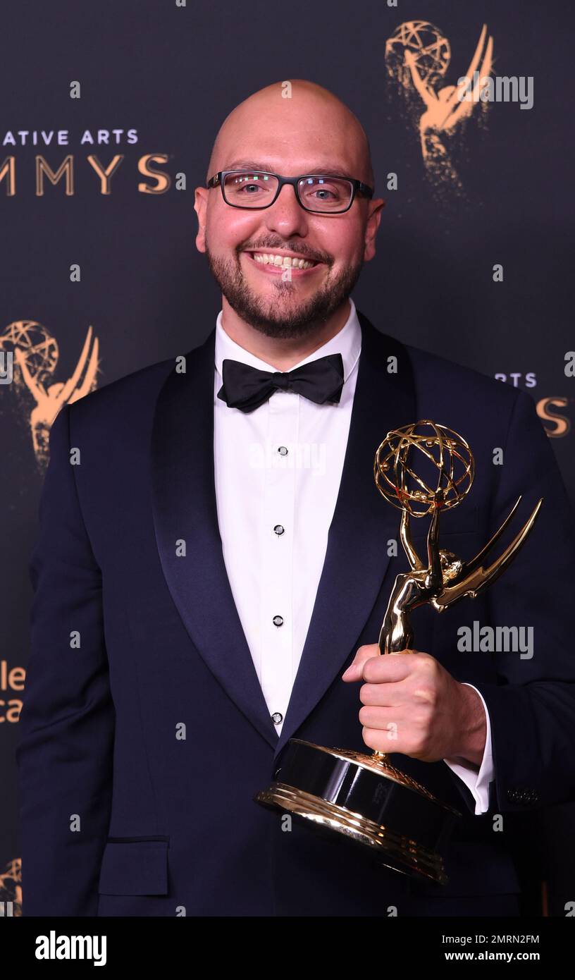 Anthony Miale poses in the press room with the award for outstanding ...