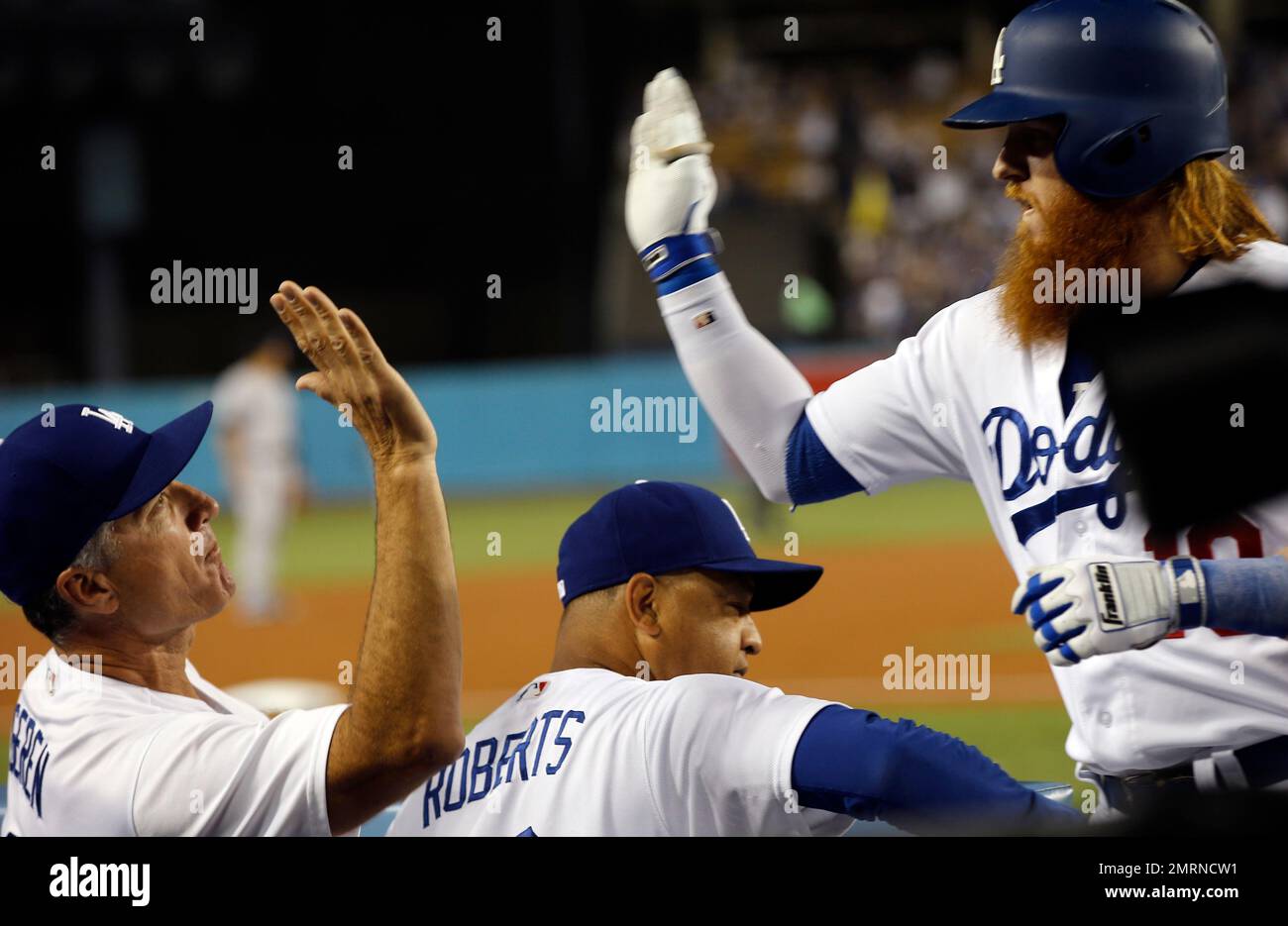 Los Angeles Dodgers' Justin Turner, right, gets congratulations from ...