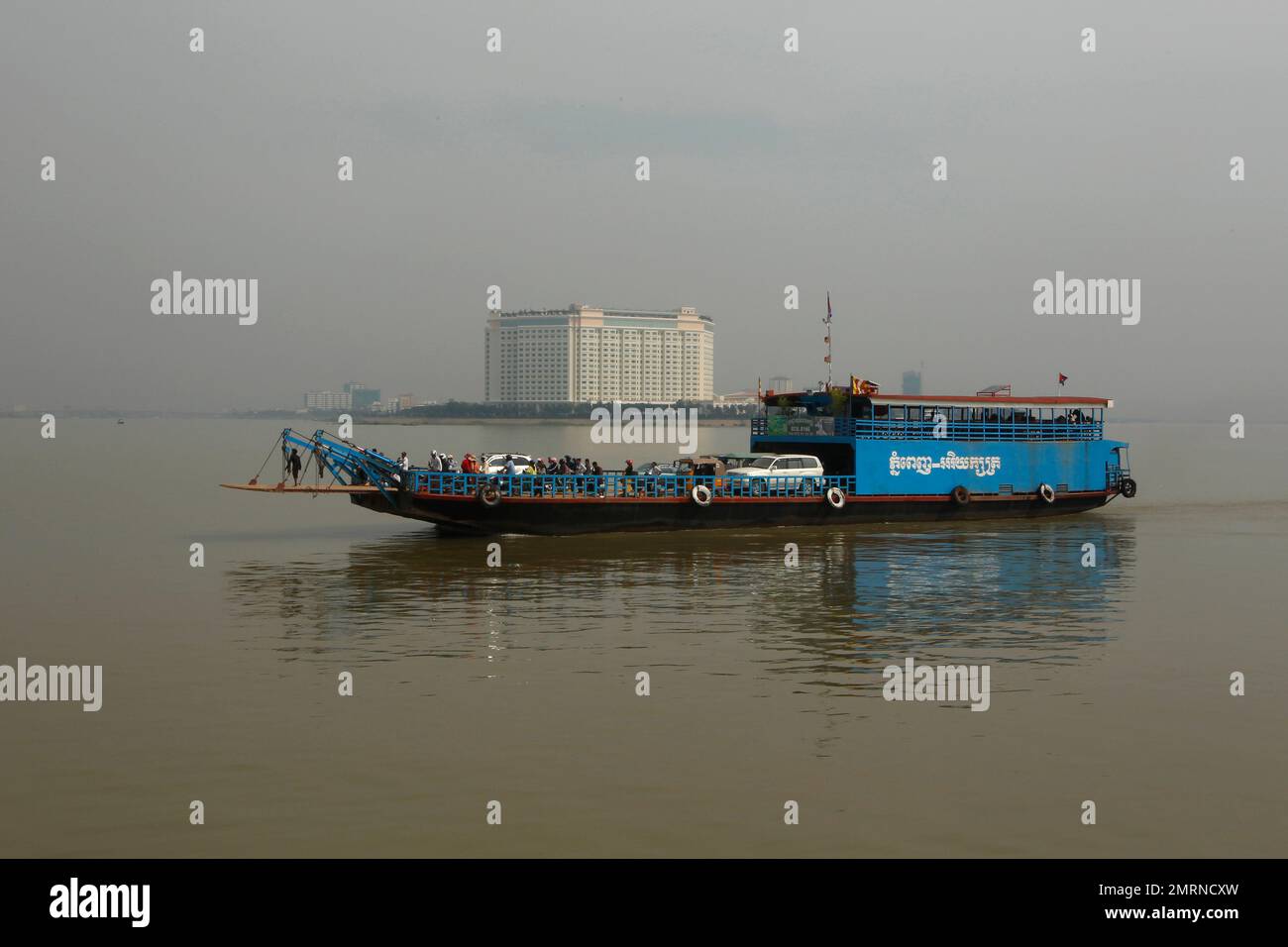 Passengers use a ferry to cross the Mekong river from Arey Ksat to ...