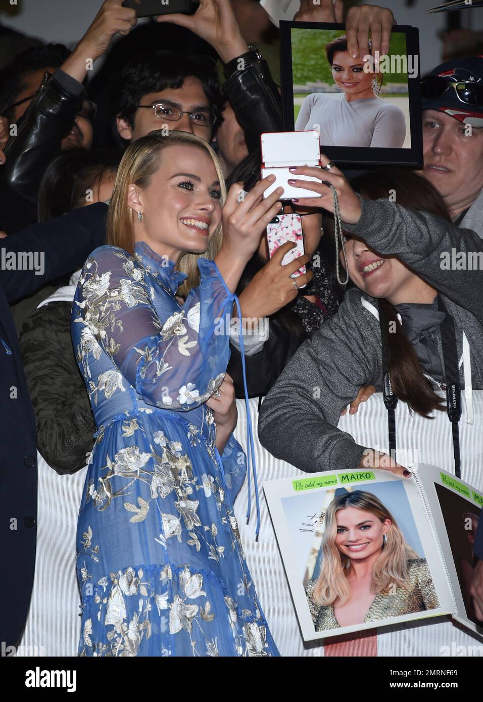 Margot Robbie takes a selfie with fans at a premiere for "I, Tonya" on ...