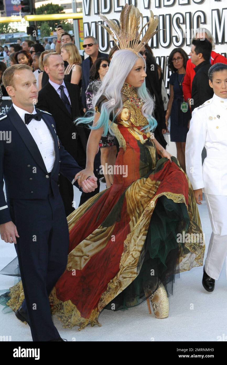 Global pop star Lady Gaga arrives in a patterned tulle gown and gold ...