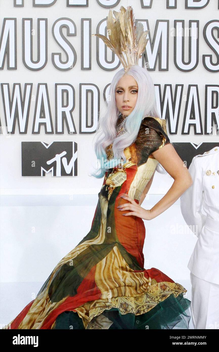 Global pop star Lady Gaga arrives in a patterned tulle gown and gold ...