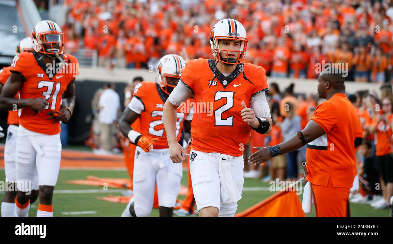 Oklahoma State quarterback Mason Rudolph (2) runs on to the field ...