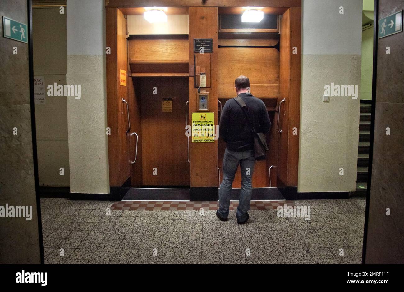 A man waits to board a paternoster elevator in Prague, Czech Republic ...