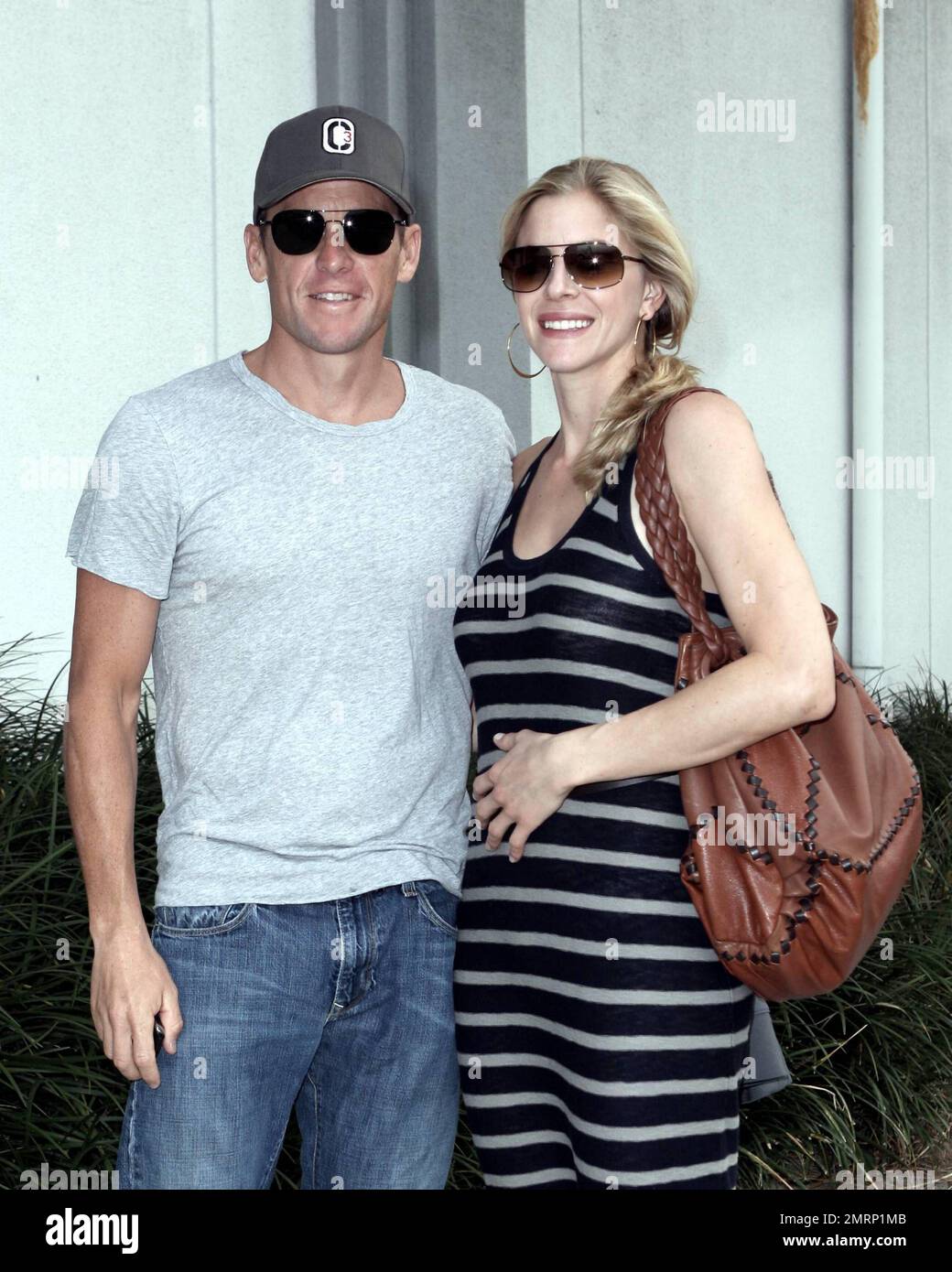 Lance Armstrong and girlfriend Anna Hansen pose for photos while attending Art Basel Miami Beach ...