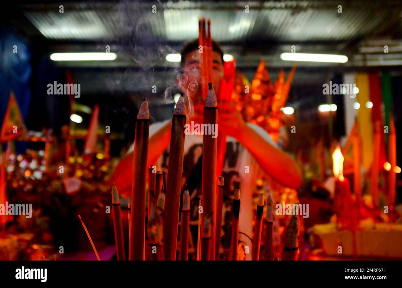 A man offer prayer to a giant paper statue of the Chinese deity "Da Shi ...