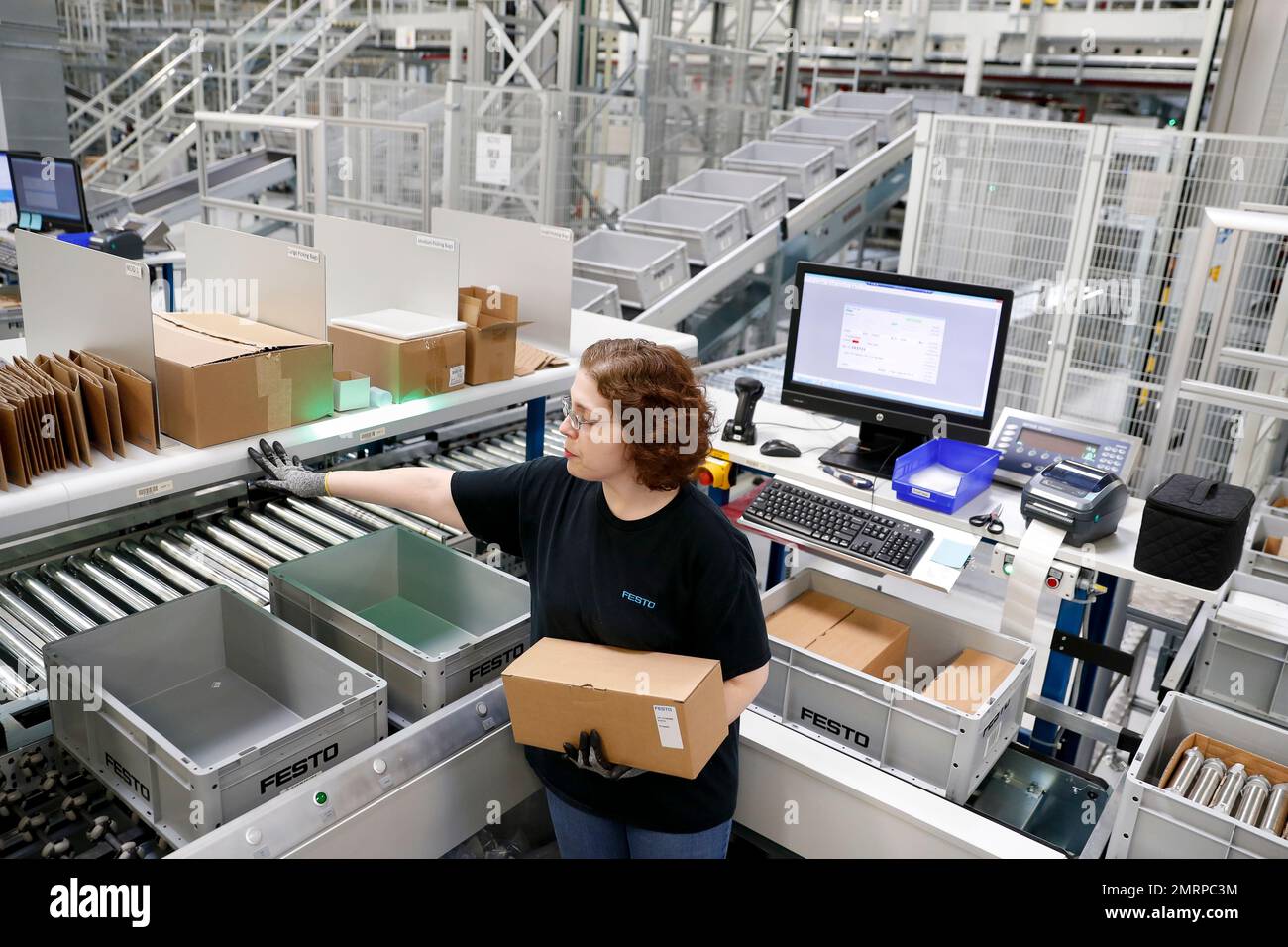 Employees man an automated distribution array intake system that sorts ...