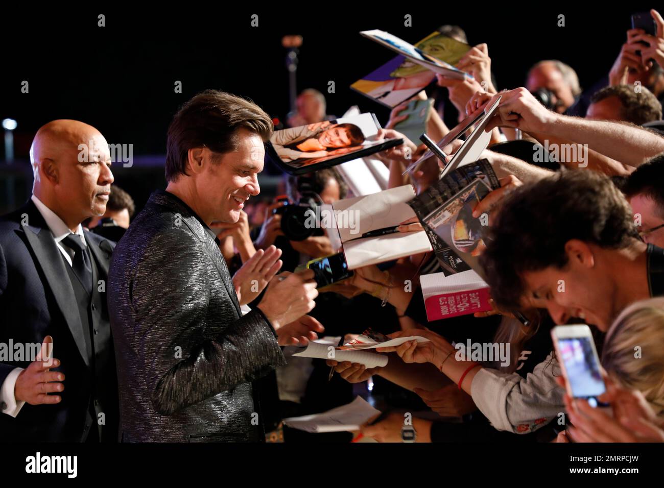 Actor Jim Carrey signs autographs at the premiere of the film 'Jim and ...