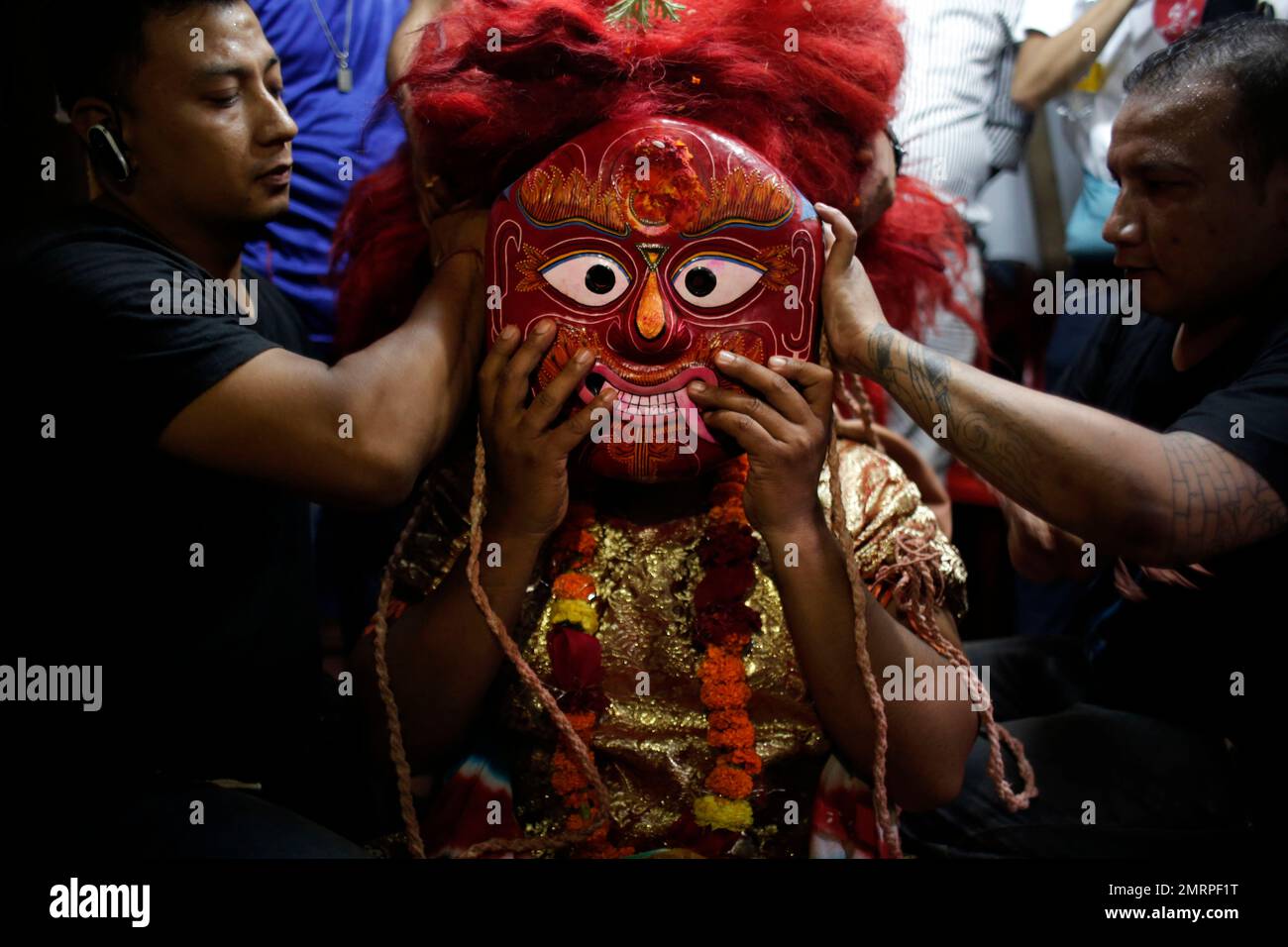 A traditional mask dancer, known as Lakhe, gets dressed for the Indra ...