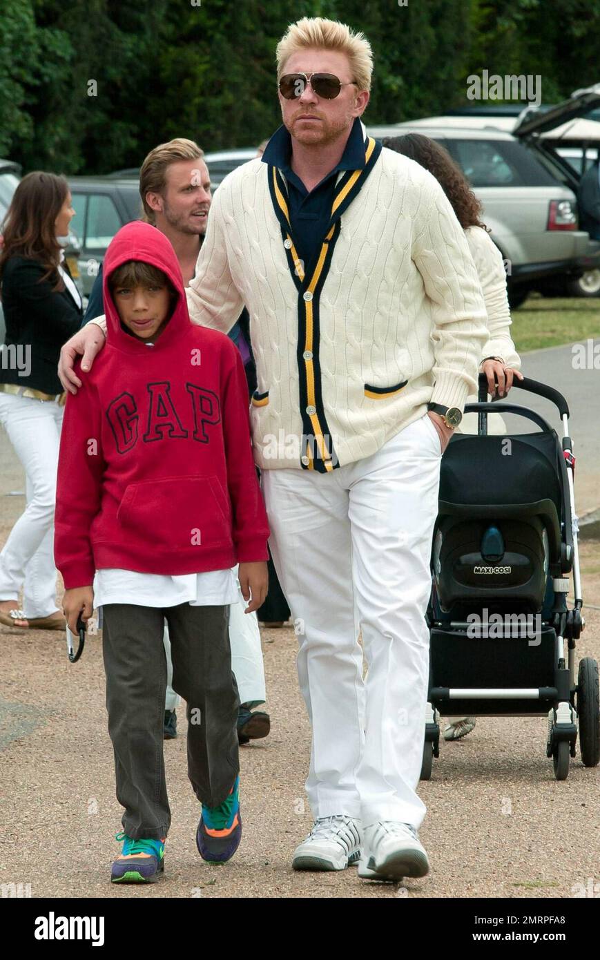 Boris Becker walks with his son Elias while attending the Laureus Polo ...
