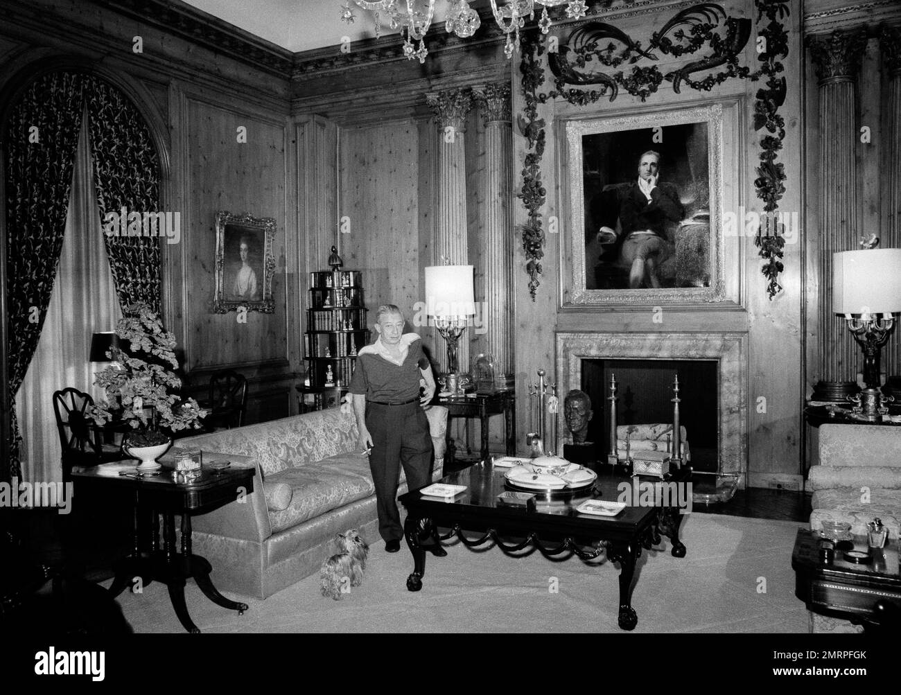 Billy Rose poses in spacious living room of his New York City townhouse ...