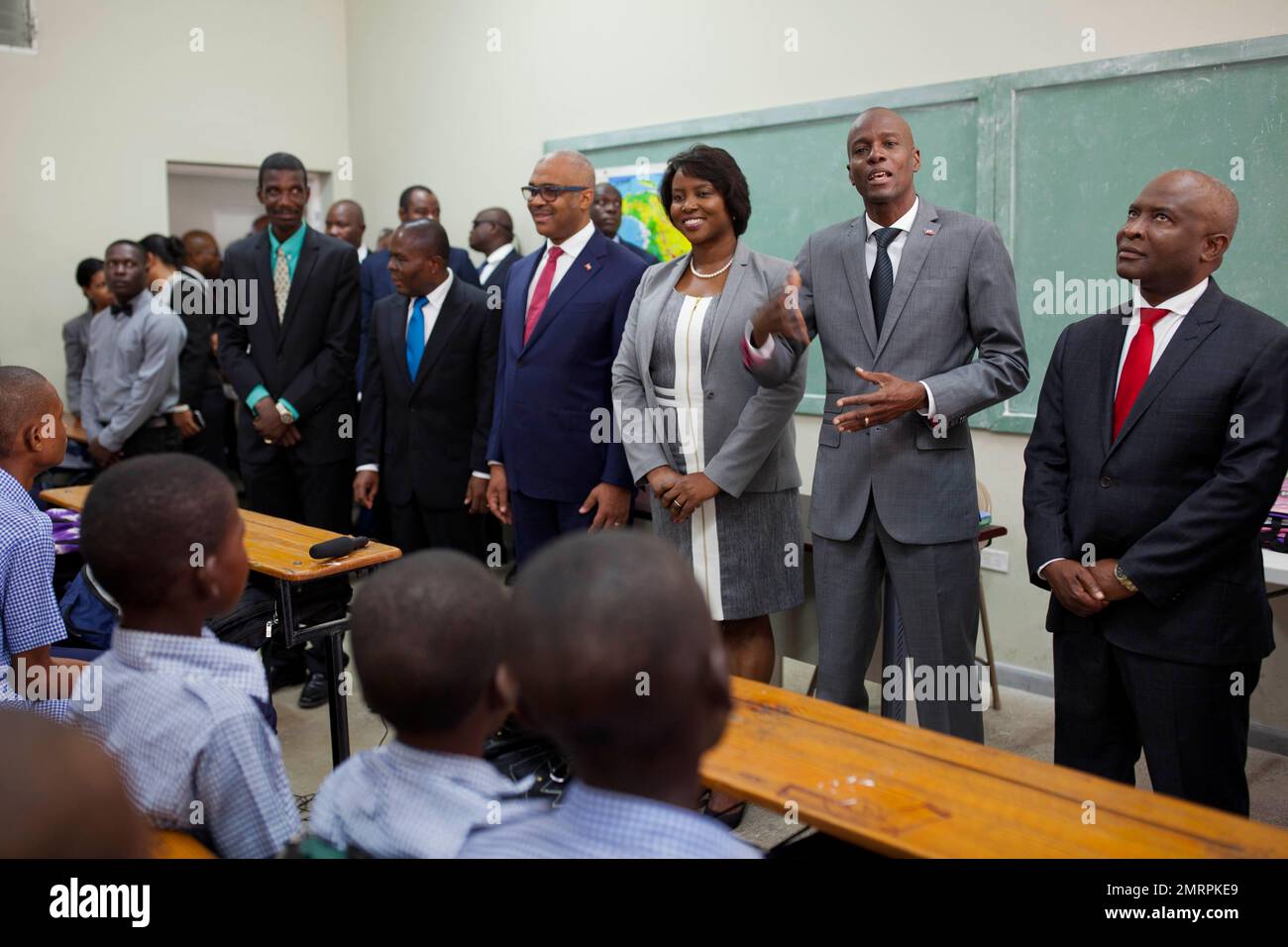 Haiti's President Jovenel Moise, second from right, talks to students ...