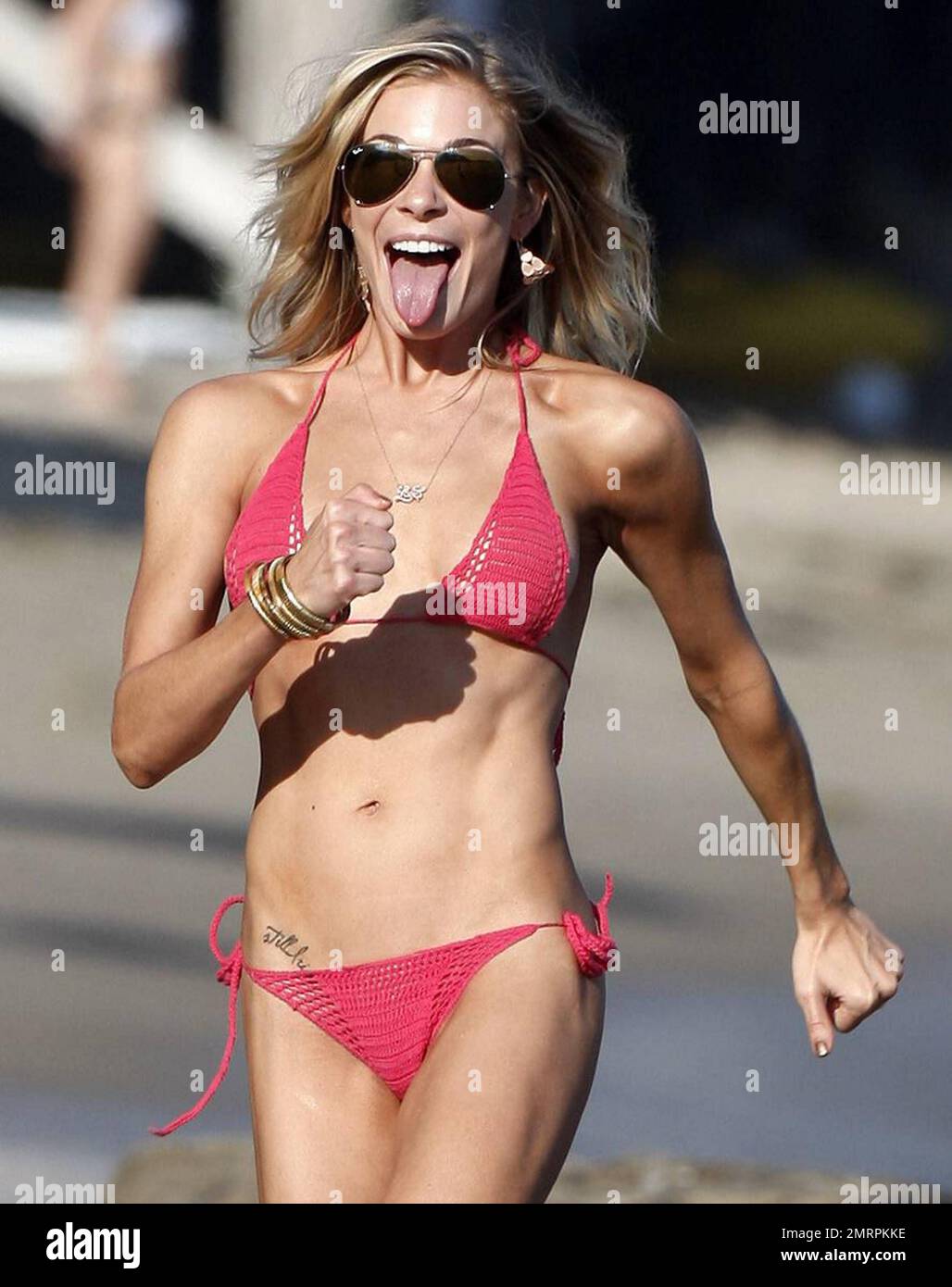American country musician LeAnn Rimes seems joyful while she dazzles in a tiny coral bikini as ...