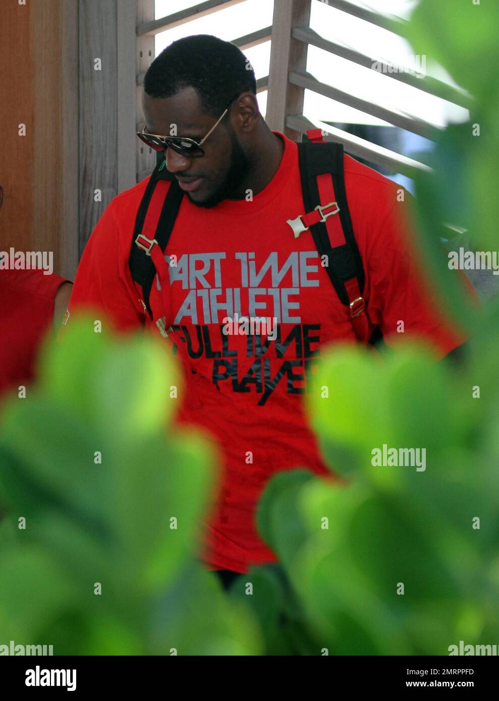 Lebron James pulls his shirt on following a day at the pool. Miami, FL ...
