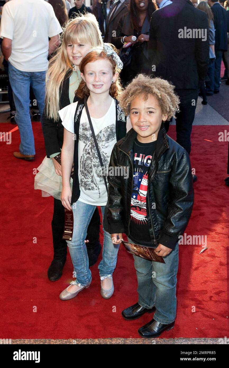 Maisie Smith (C), Devon Higgs (R) and guest pose for photographers on ...
