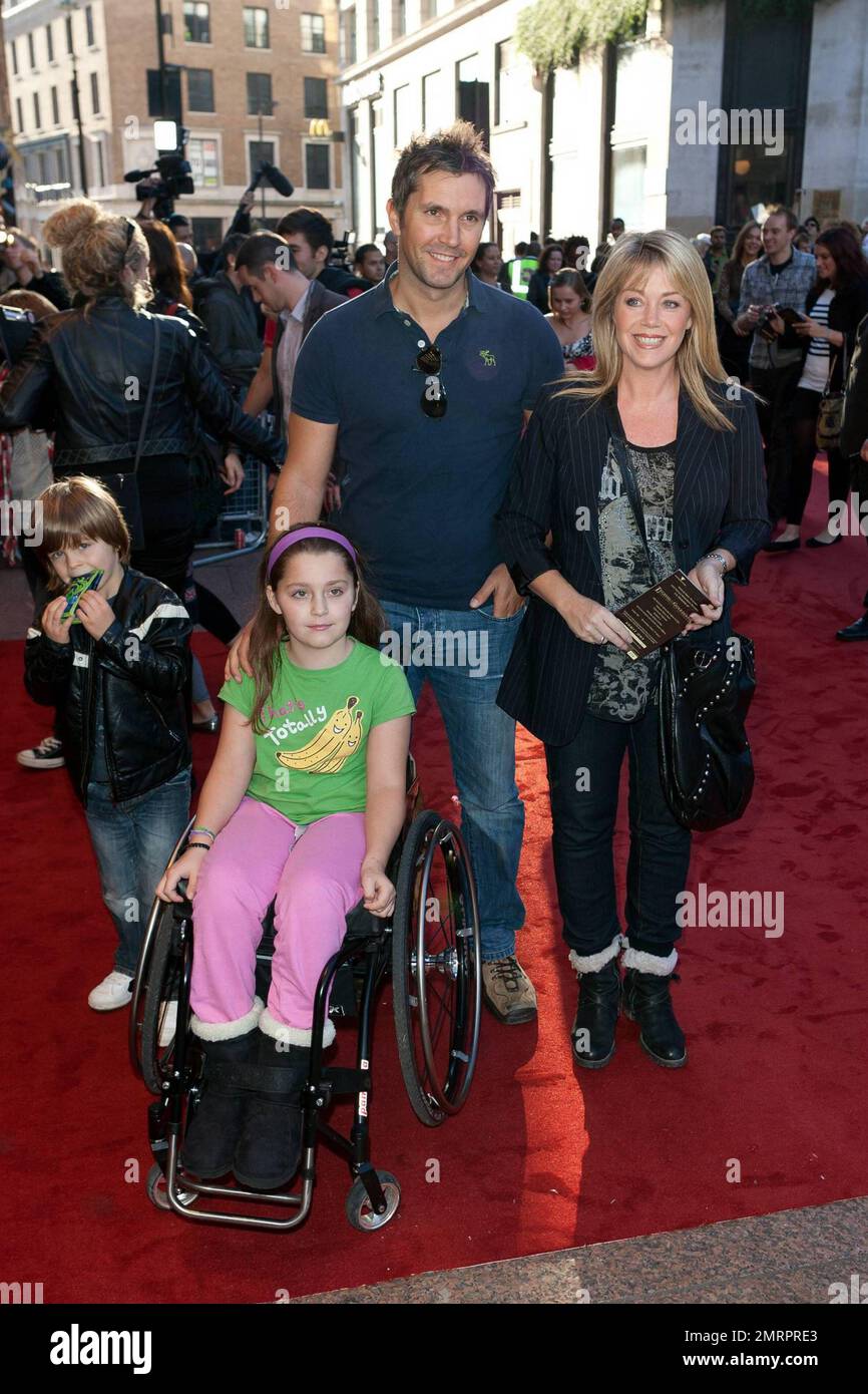 Lucy Alexander (R) and family pose for photographers on the red carpet ...