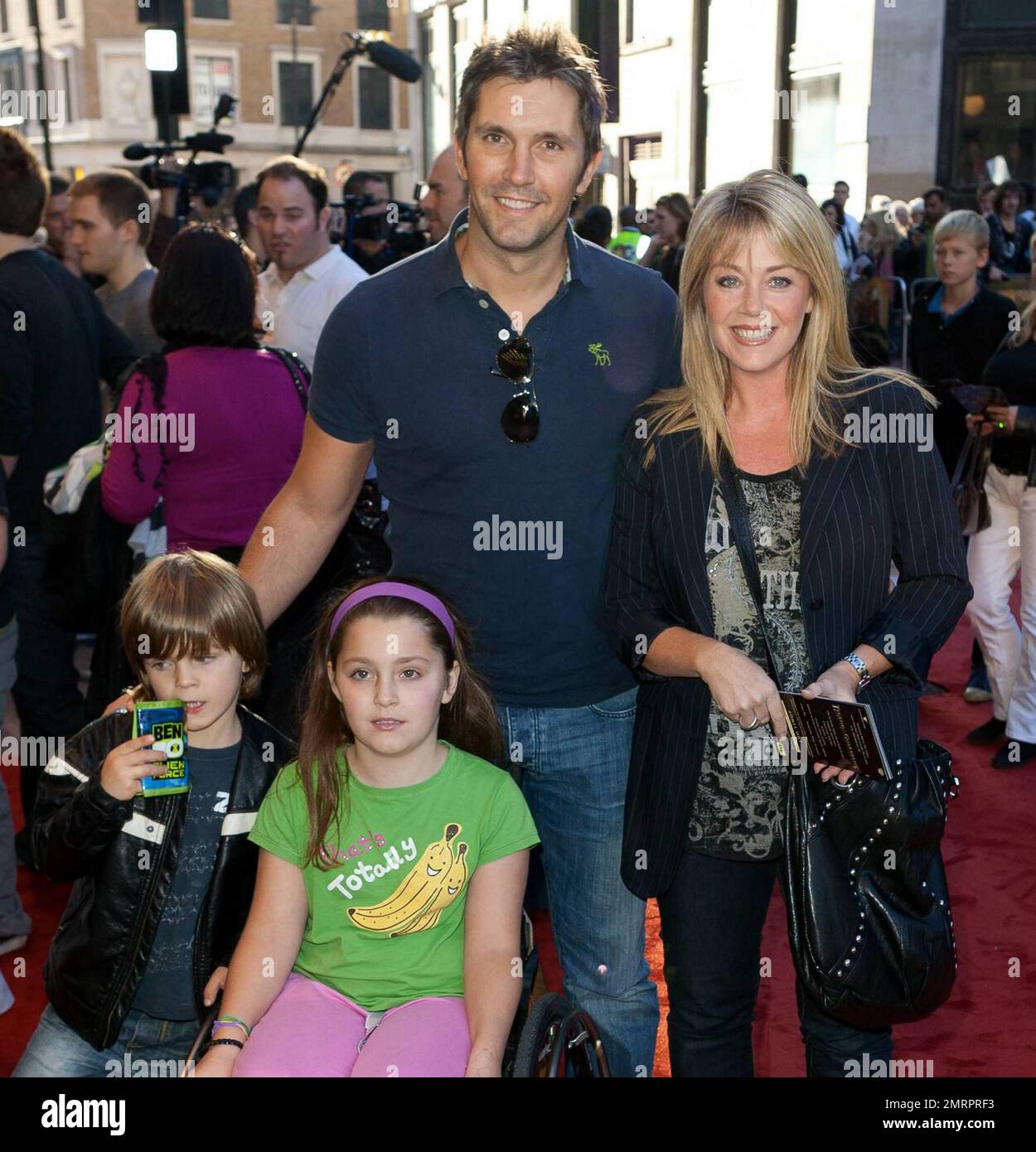 Lucy Alexander (R) and family pose for photographers on the red carpet ...