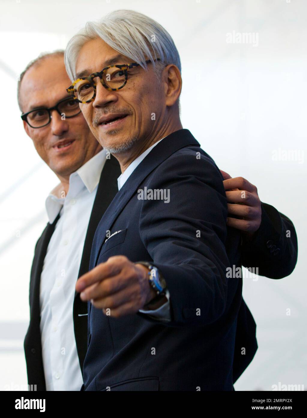 Maestro Ryuichi Sakamoto, right, poses with director Stephen Nomura Schible during a photo call ...
