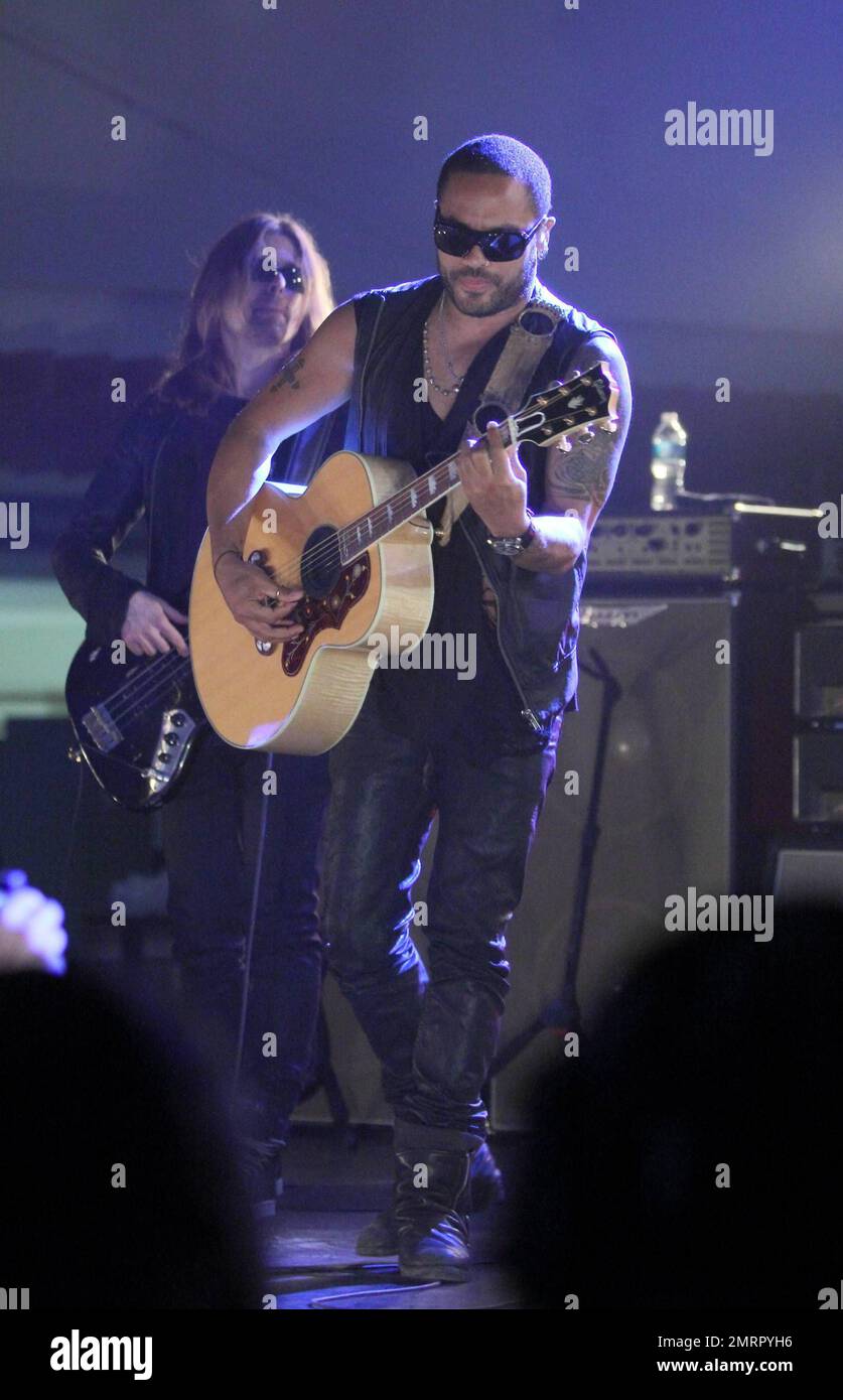 Lenny Kravitz shows off his tattoos in a sleeveless leather vest as he ...
