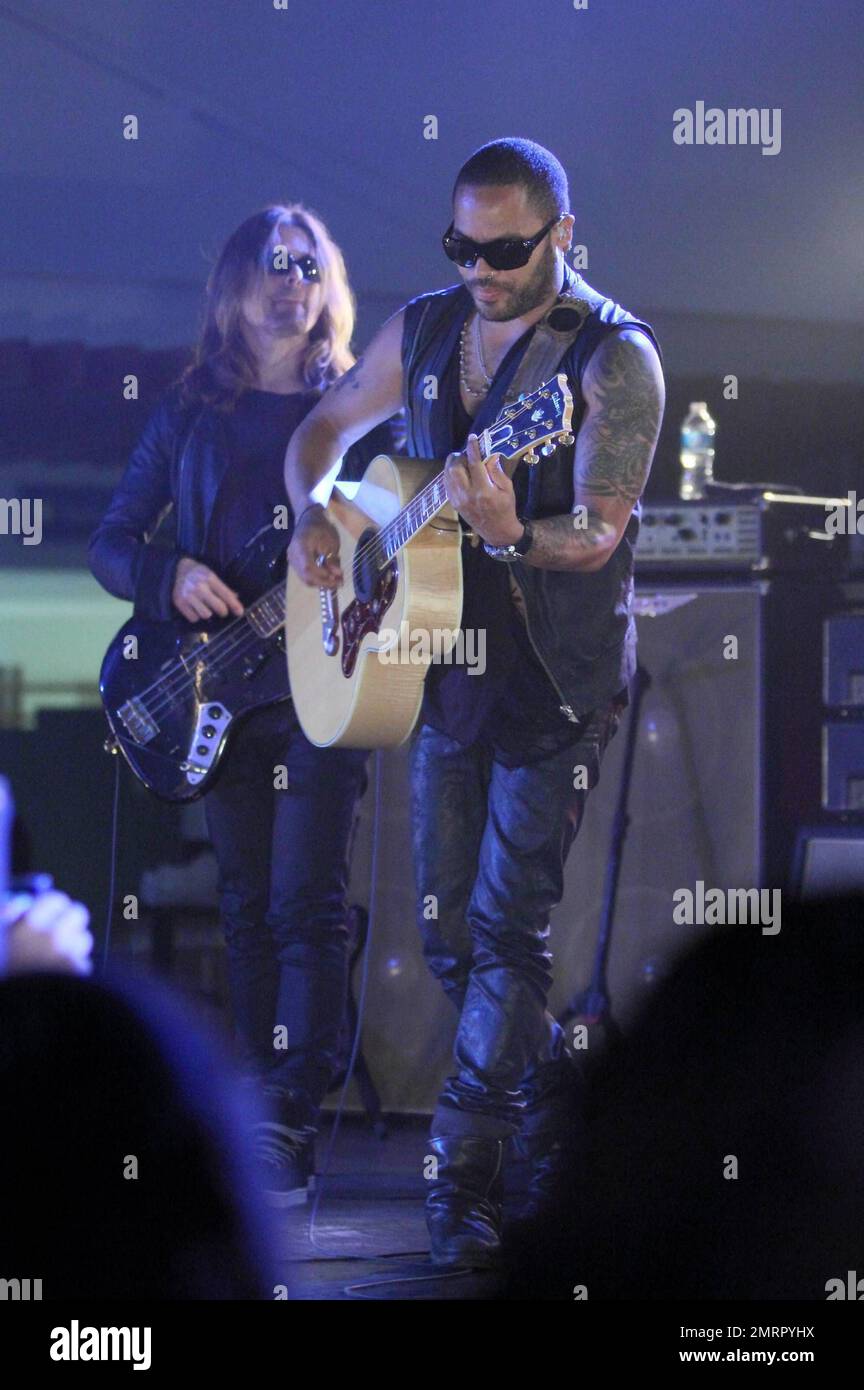 Lenny Kravitz shows off his tattoos in a sleeveless leather vest as he ...