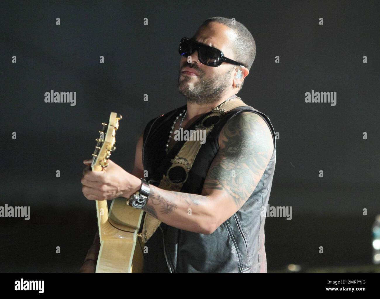 Lenny Kravitz shows off his tattoos in a sleeveless leather vest as he ...