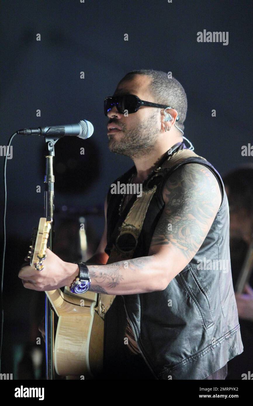 Lenny Kravitz shows off his tattoos in a sleeveless leather vest as he ...