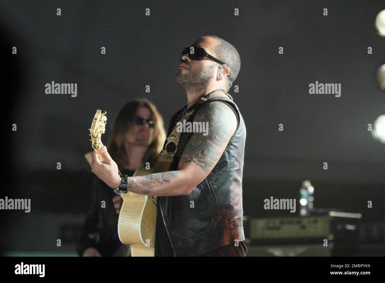 Lenny Kravitz shows off his tattoos in a sleeveless leather vest as he ...