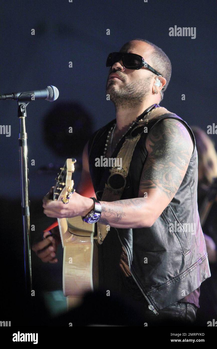 Lenny Kravitz shows off his tattoos in a sleeveless leather vest as he ...