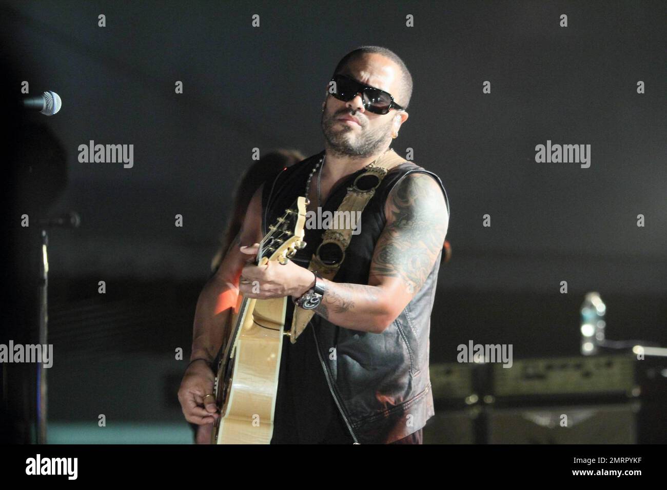 Lenny Kravitz shows off his tattoos in a sleeveless leather vest as he ...