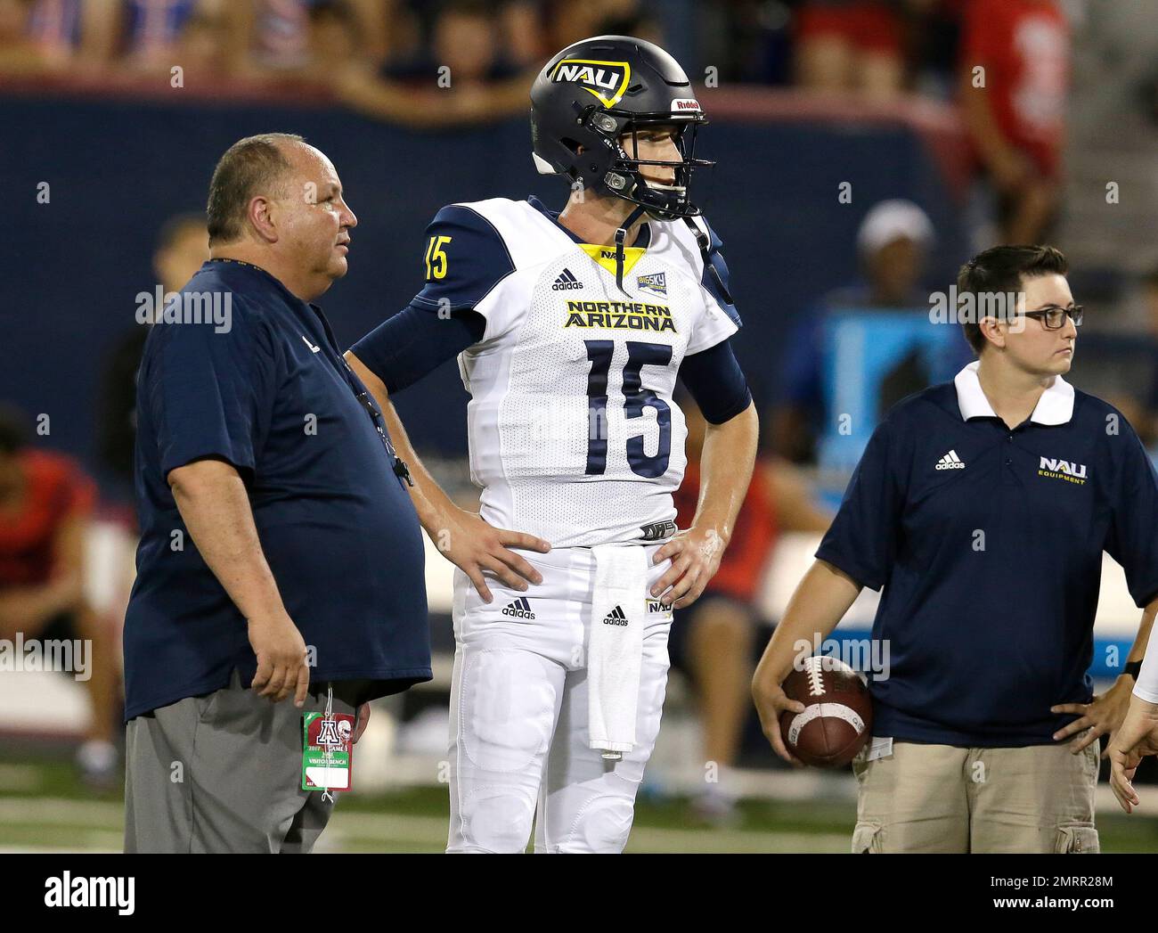 Northern Arizona quarterback Case Cookus (15) and head coach Jerome ... Northern Arizona quarterback Case Cookus (15) and head coach Jerome ...