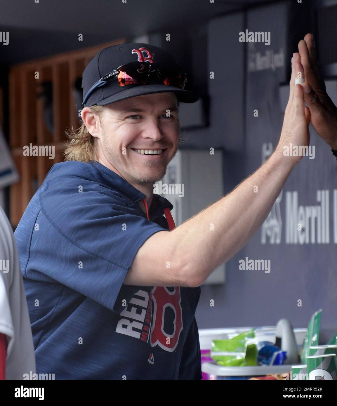 Boston Red Sox left fielder Brock Holt high-fives in the dugout before ...
