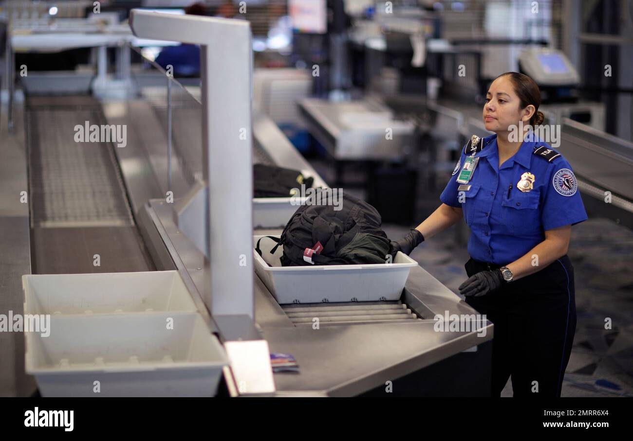 In this Sept. 1, 2017, photo, a TSA officer grabs a bin for additional ...