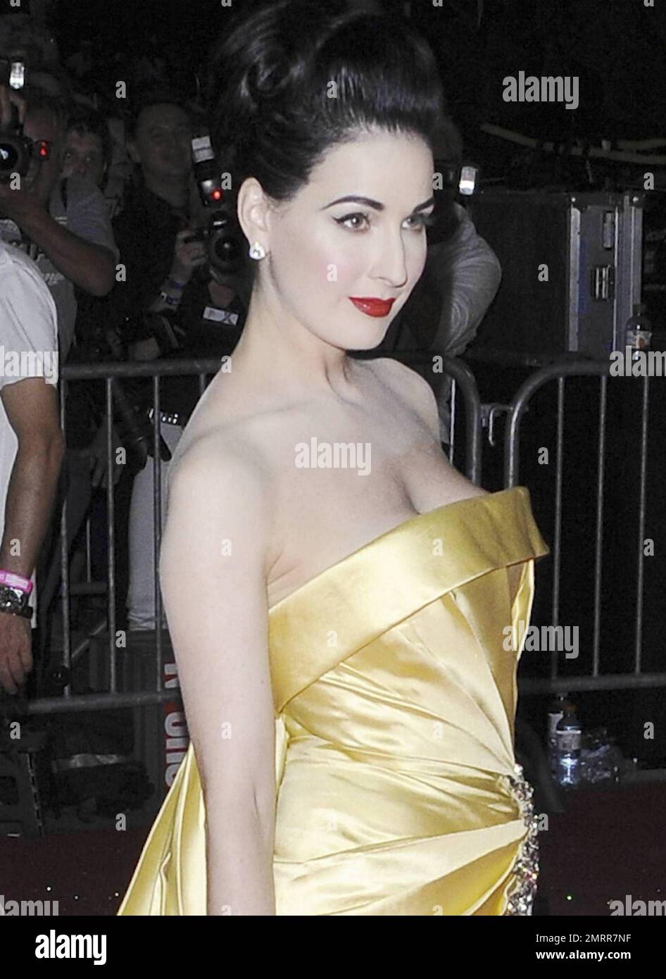 Burlesque star Dita von Teese glows in her yellow satin gown on the red ...