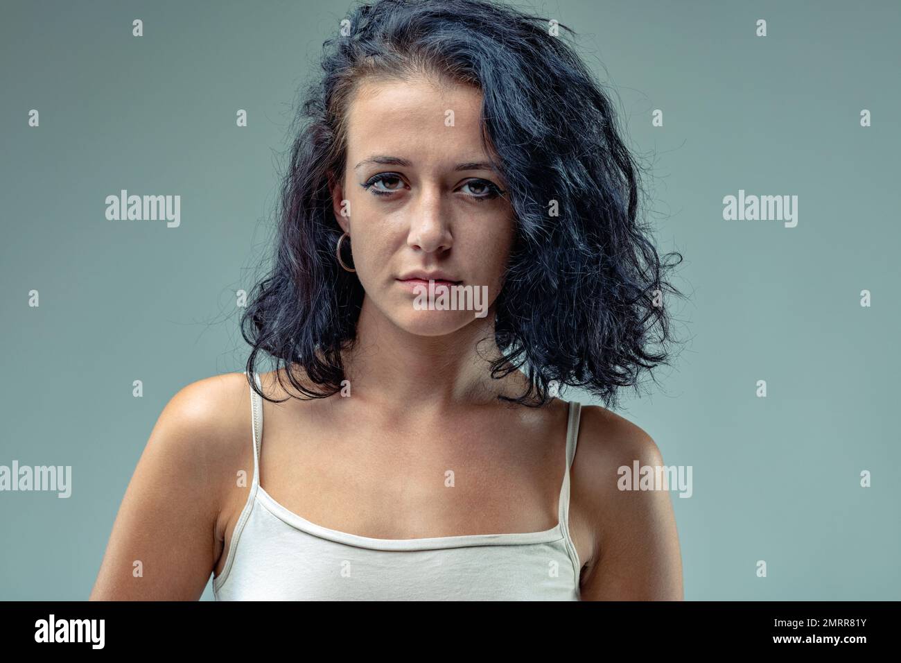 Frontal portrait of serious girl. Determined or about to get angry? She ...