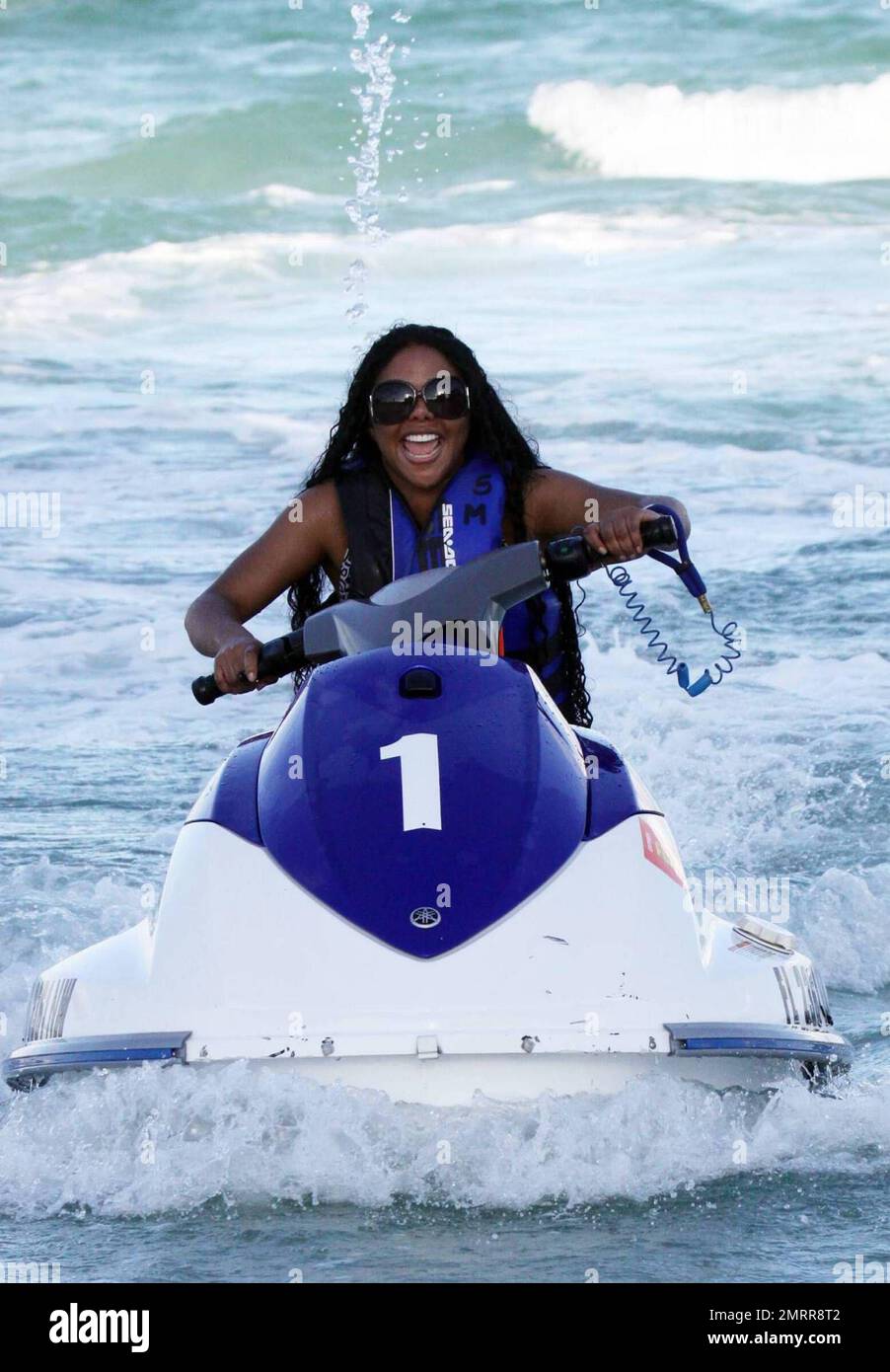 Lil' Kim and her girlfriends enjoy an afternoon at the beach playing on ...