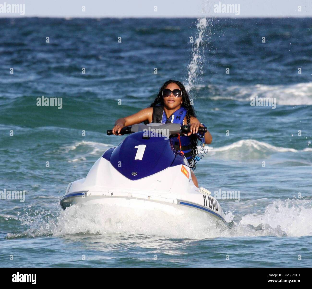 Lil' Kim and her girlfriends enjoy an afternoon at the beach playing on ...