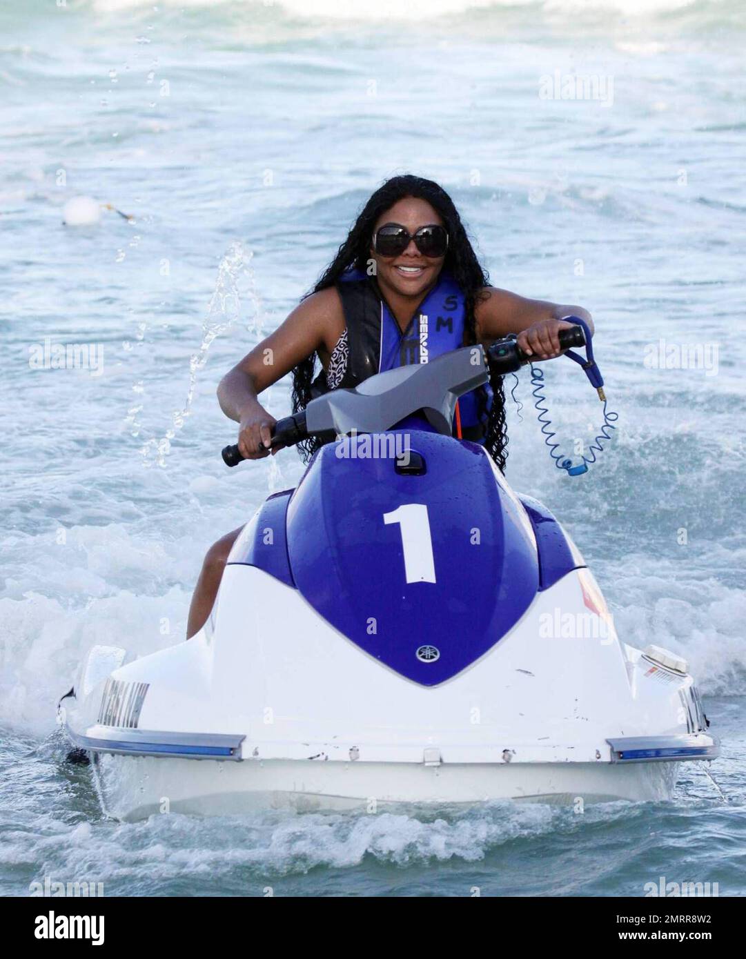 Lil' Kim and her girlfriends enjoy an afternoon at the beach playing on ...
