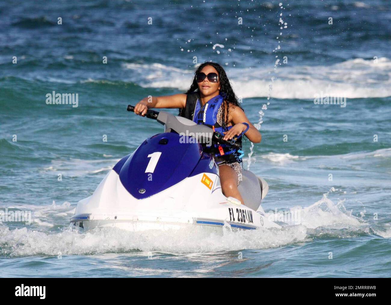 Lil' Kim and her girlfriends enjoy an afternoon at the beach playing on ...