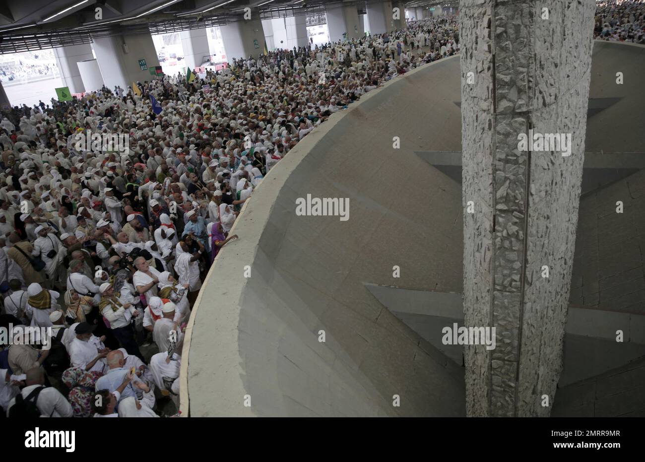 Muslim pilgrims cast stones at three huge stone pillars in the symbolic ...