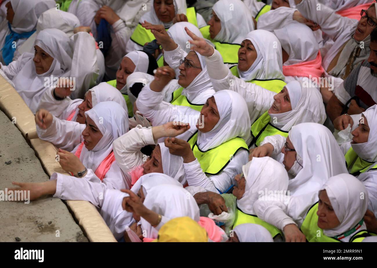 Muslim pilgrims cast stones at three huge stone pillars in the symbolic ...