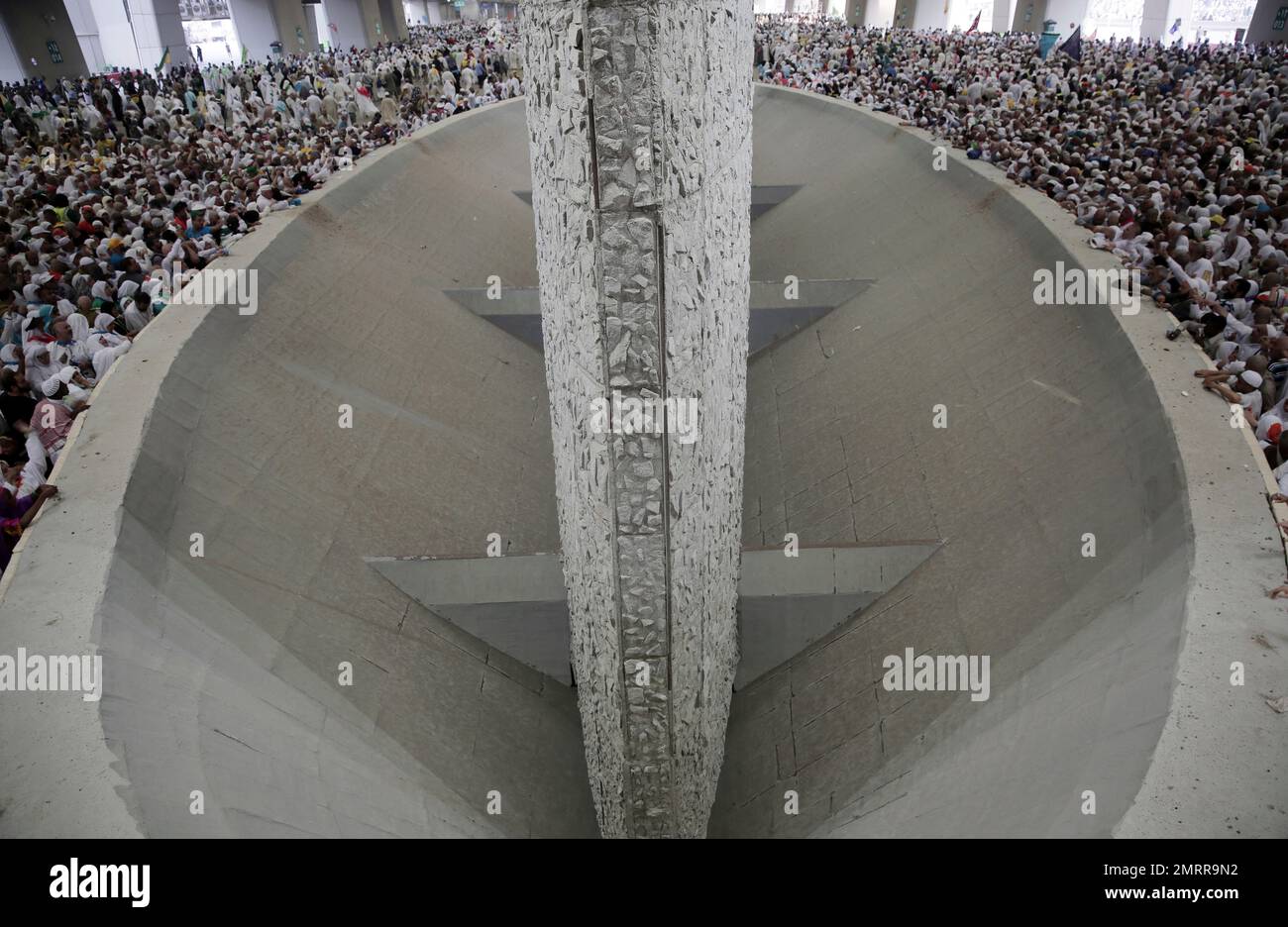 Muslim pilgrims cast stones at three huge stone pillars in the symbolic ...