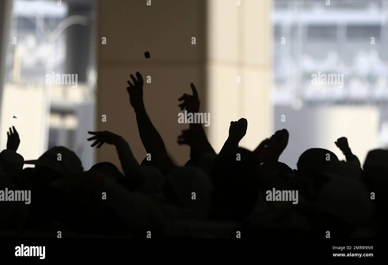 Muslim pilgrims cast stones at three huge stone pillars in the symbolic ...